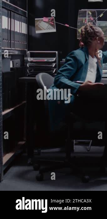 Vertical Video African American Policewoman Reviewing Case Files