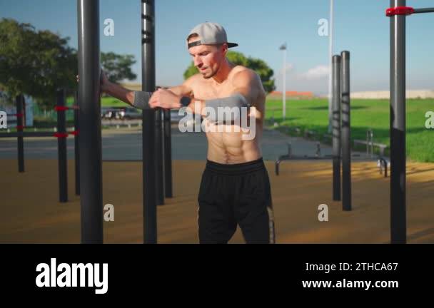 Athletic man stretching body holding crossbar on modern calisthenics ...