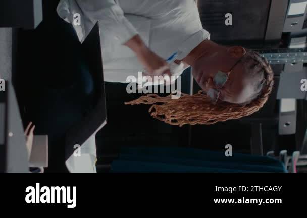 Vertical video: Female detective reading records on criminal case ...