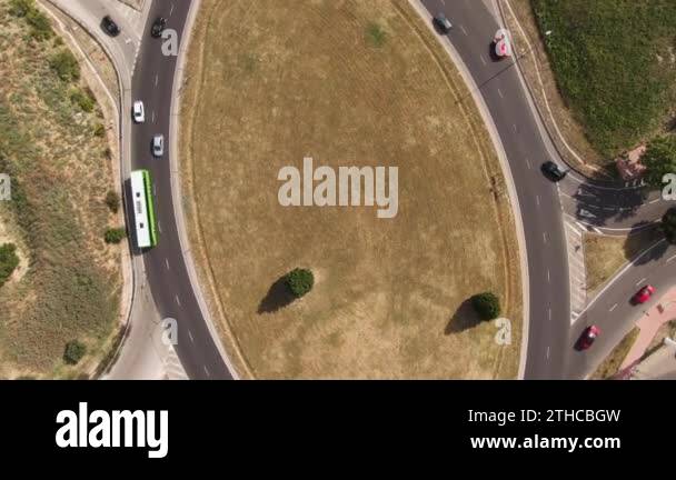 Ellipse shape roundabout in Spain with vehicles and public busses ...