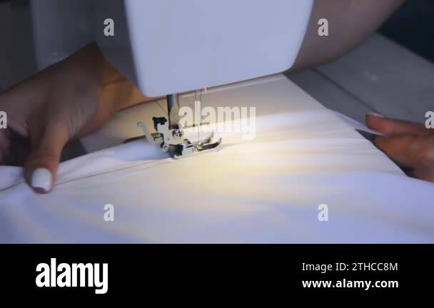 experienced worker works on a sewing machine. hands close up. workshop ...