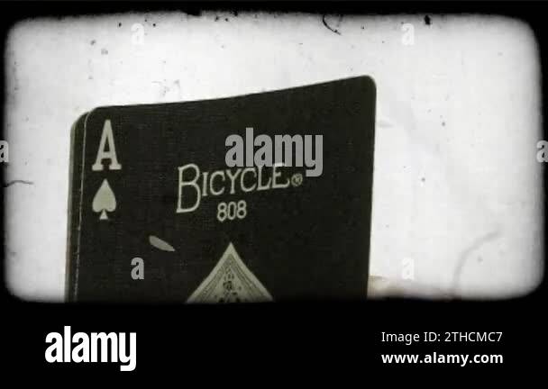 A hand holding a bicycle brand ace card. From behind the ace a royal ...