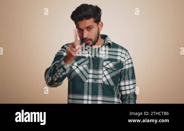 Indian handsome man shakes finger and saying No, be careful, scolding ...