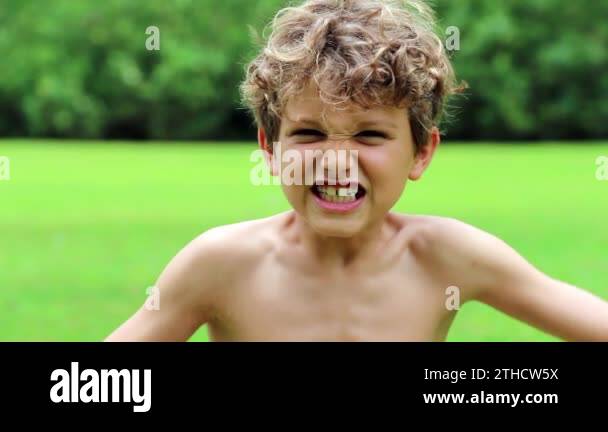 Kid screaming in ultra slow-motion. Young boy shouting and yelling ...