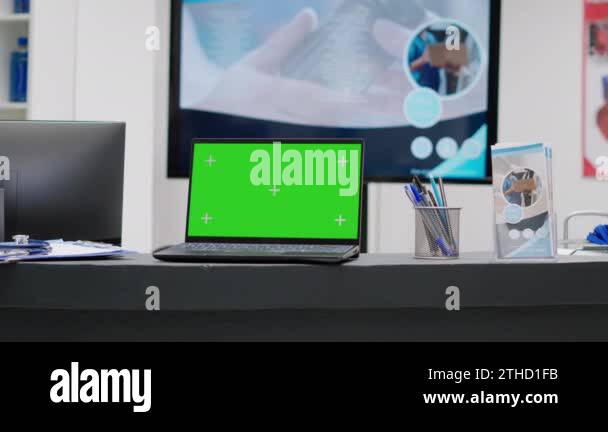 Greenscreen on laptop at hospital reception desk in medical waiting ...