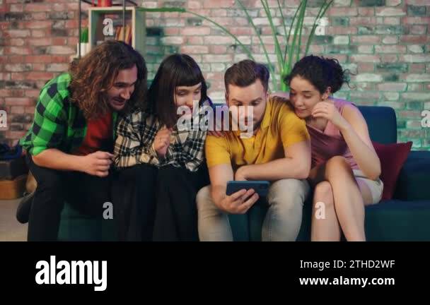 Good looking group of multiracial friends together watching a match on ...