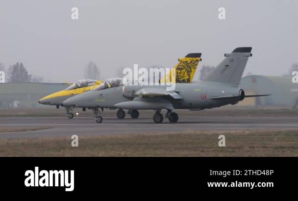 Fighter jet airplanes taxiing on military airport runway. First ...