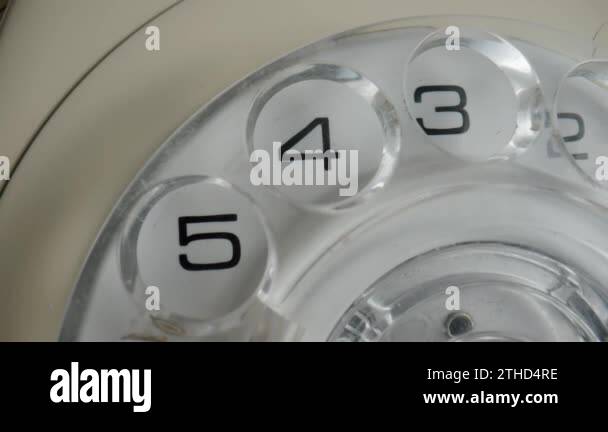 Male finger rotating the dialer. Man is dialing phone number on an old ...