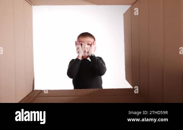 Little happy boy, child unpacking, opening cardboard box with happy ...