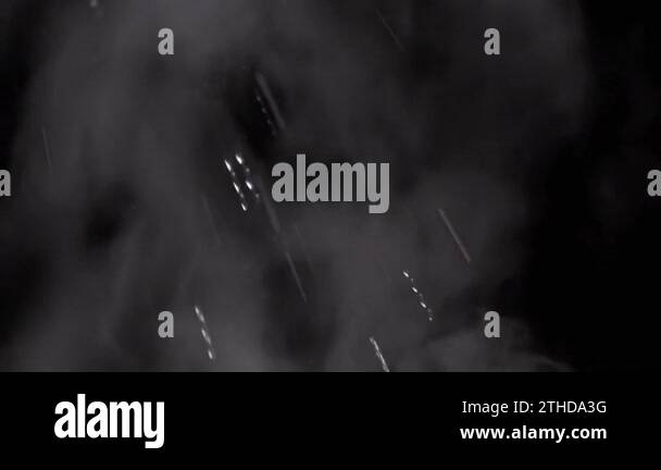 Falling Stream of Splashes on a Rising Cloud of Water Vapor on Black ...