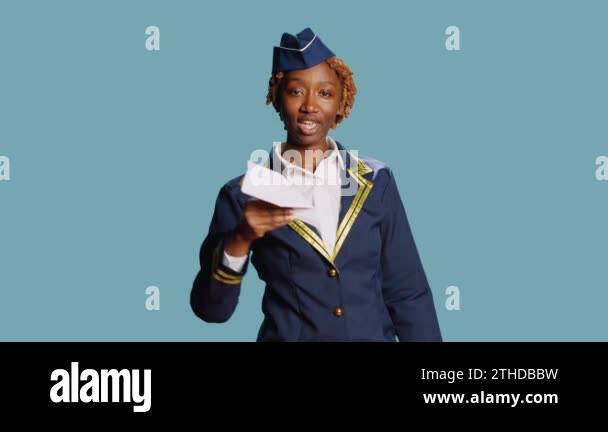 Female model showing folded airplane in studio, playing with paper ...
