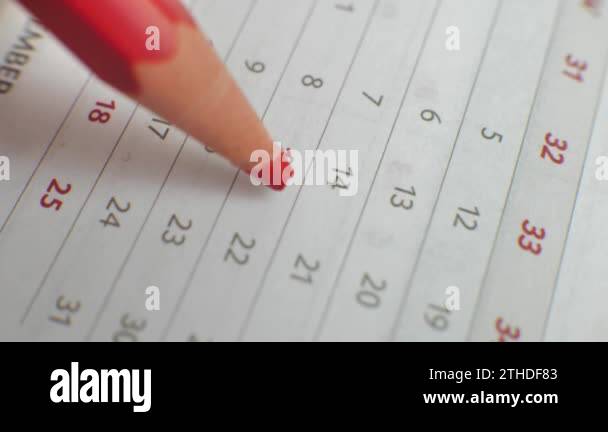 Wall calendar, the number of the month is crossed out. A hand crosses ...