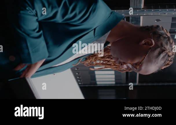 Vertical video: Police investigator reading case file in evidence room ...