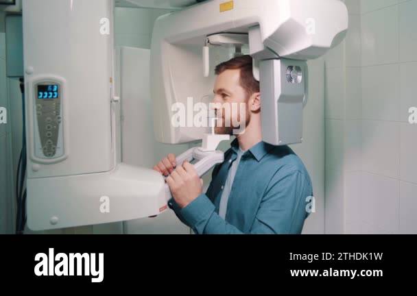 Young male patient undergoing panoramic X-ray investigation of oral ...