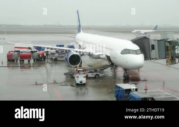 Passenger airliner with a docked telescopic landing ramp on the ...