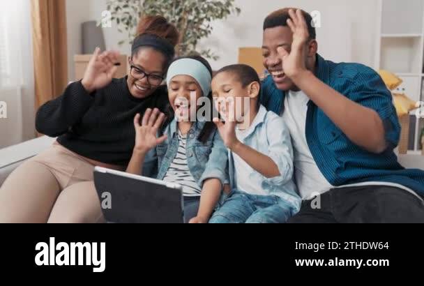 The family is spending time together on the couch, the parents and ...