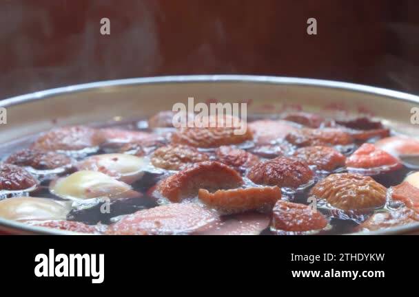 Process of preparing fruit drink. Fruit slices are boiled in boiling ...
