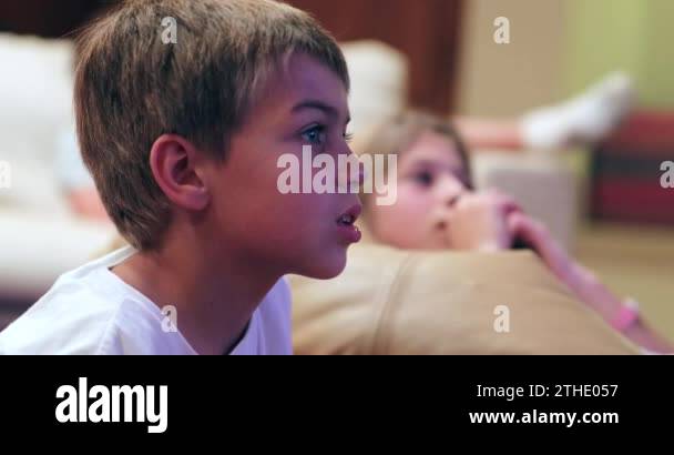 Young boy in front of tv screen watching movie with real life authentic ...