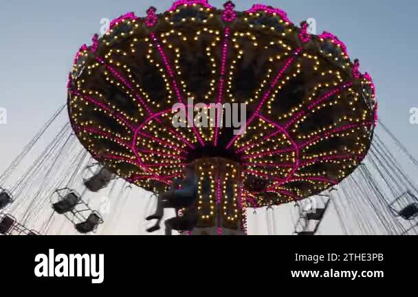 The chain carousel spins in a circle. Amusement and recreation park ...