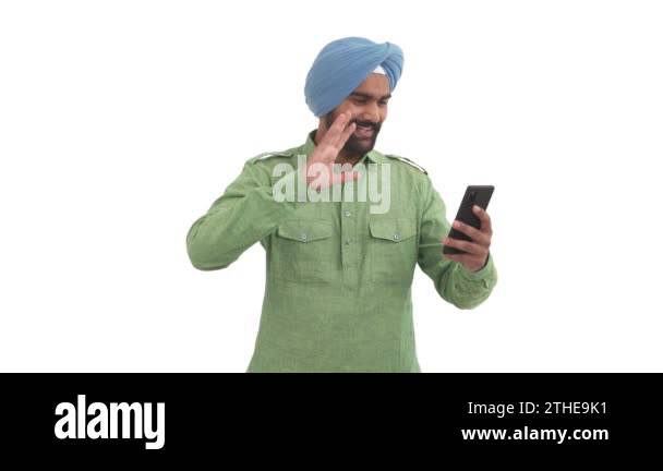 Young beard Indian man talking with friend by video call. Guy enjoying ...