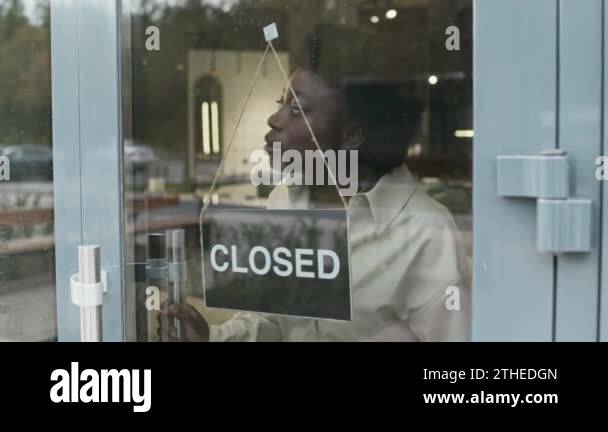 Locked down of young African American female jewelry store manager ...