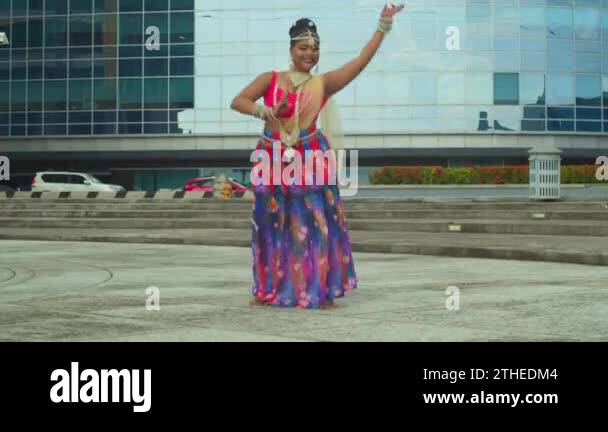 East Indian girl performing an Indian traditional dance in the city of ...