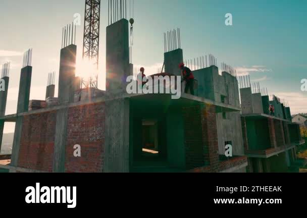 building a brick house. Builders unpack a pallet with bricks. Work ...