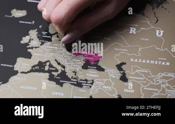 Female hand scratching the surface of a scratch map with Poland country ...