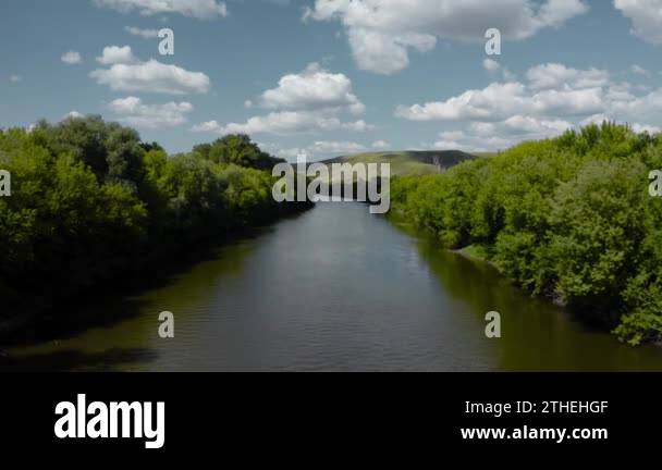 Dark river between two hills. Top view. The camera is moving forward ...