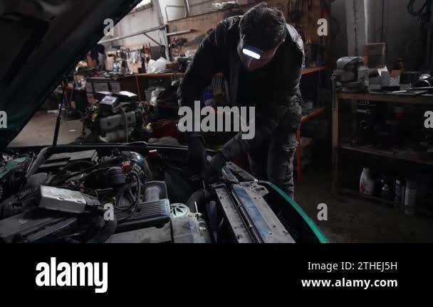 a mechanic disassembles a car to install a turbo engine tuning drift ...