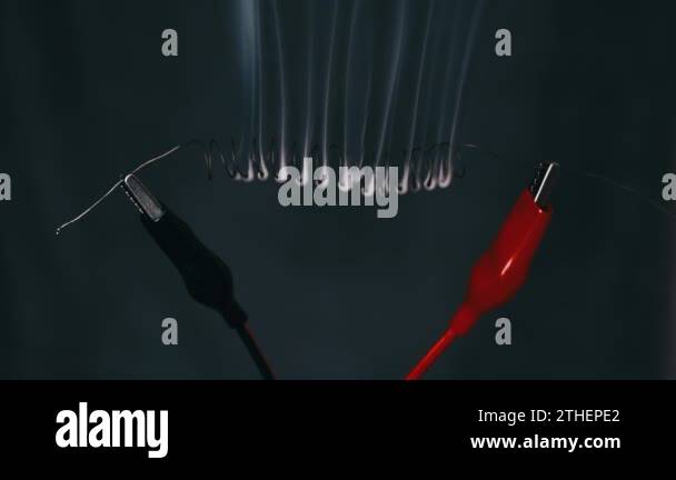The nichrome wire heats up to red with smoke under high electric ...