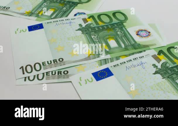 Recalculation of money. EU euro banknotes are falling on a white ...