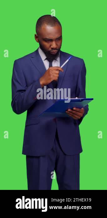 Vertical video: Front view of pensive worker thinking about writing ...