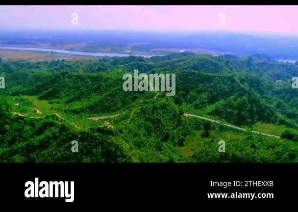 A narrow path runs through the green hills. 4K drone footage. This is ...