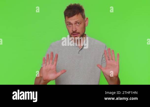 Hey you, be careful. Young man warning with admonishing finger gesture ...