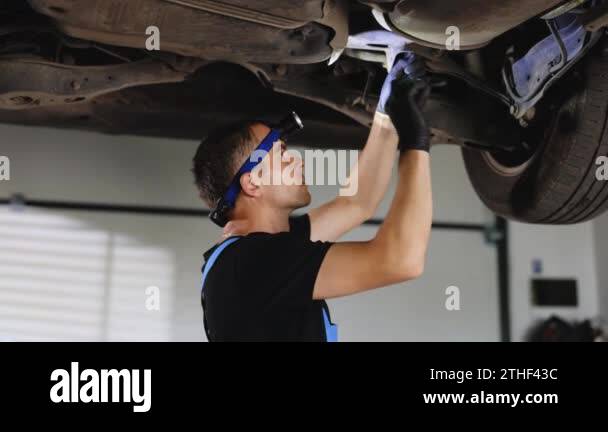 Slow Motion Footage of Male Mechanic Working on Vehicle in Car Service ...
