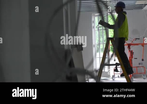 Hard male work on construction site. Two professional workers in ...