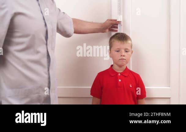 Physical therapist measuring height of a boy. Pediatric concept ...