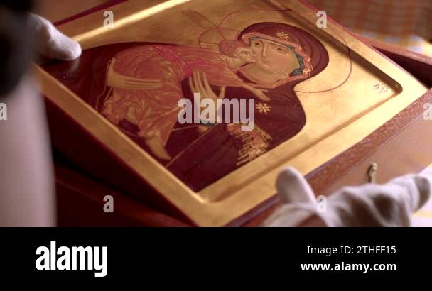Close-up of the hands of a religious scholar talking about the symbols ...