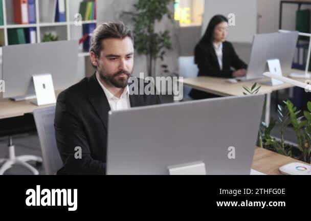 Professional male programmer using modern computer while working in ...