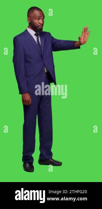 Vertical video: Side view of negative businessman doing stop sign with ...