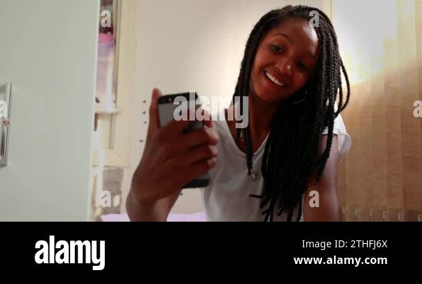 Black girl taking selfie with phone. Mixed race teen adolescent girl ...