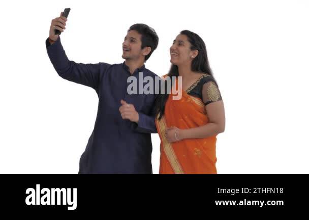 Indian couple having pleasant conversation with friends or relatives by ...