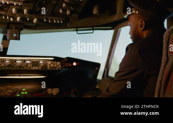 Portrait of male copilot pressing power switch buttons to takeoff and ...