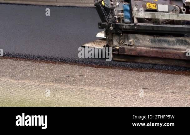 Replacing old asphalt when repairing the road surface. Asphalt paver ...