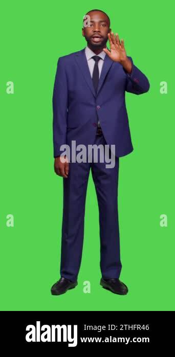 Vertical video: Front view of startup worker talking to people and ...