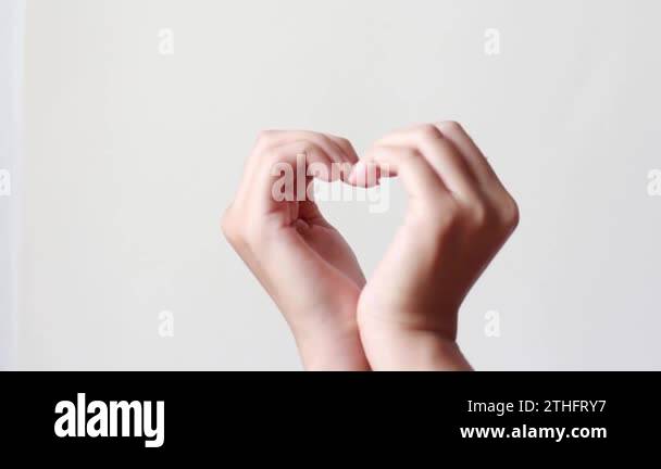 Hands make heart symbol against white background Stock Video Footage ...