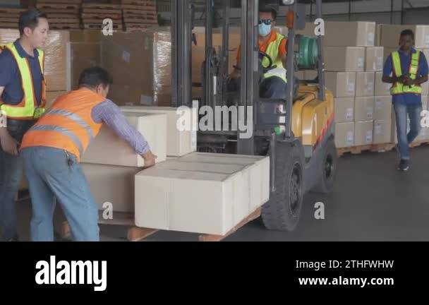 Worker lift box and accident with injured while colleagues to help in ...