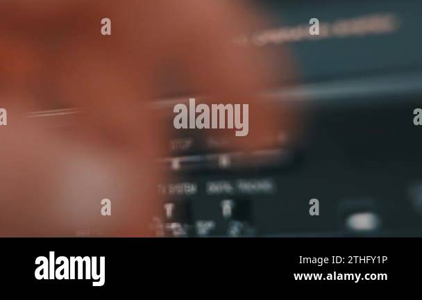 Eject VHS tape cassette from VCR player. Male hand pushes a button and ...