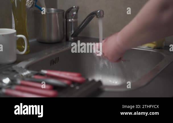 House cleaning, household chores. Washing dishes and kitchen utensils ...